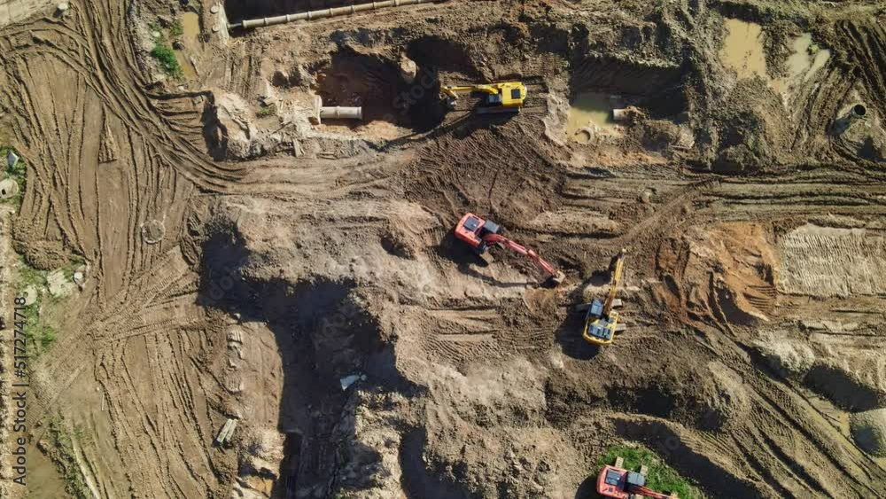 Aerial view of excavators on earthwork at construction site. Earthworks ...