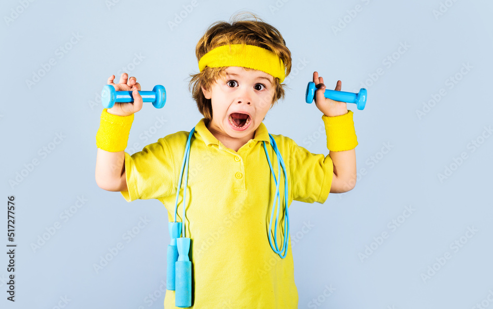 Fitness child. Sporty boy with jumping rope and dumbbells. Gym workout ...