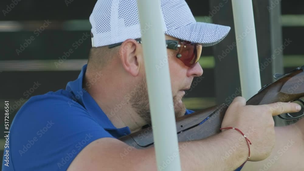 Sportsman shoots from a double-barreled shotgun, A sports field for a ...