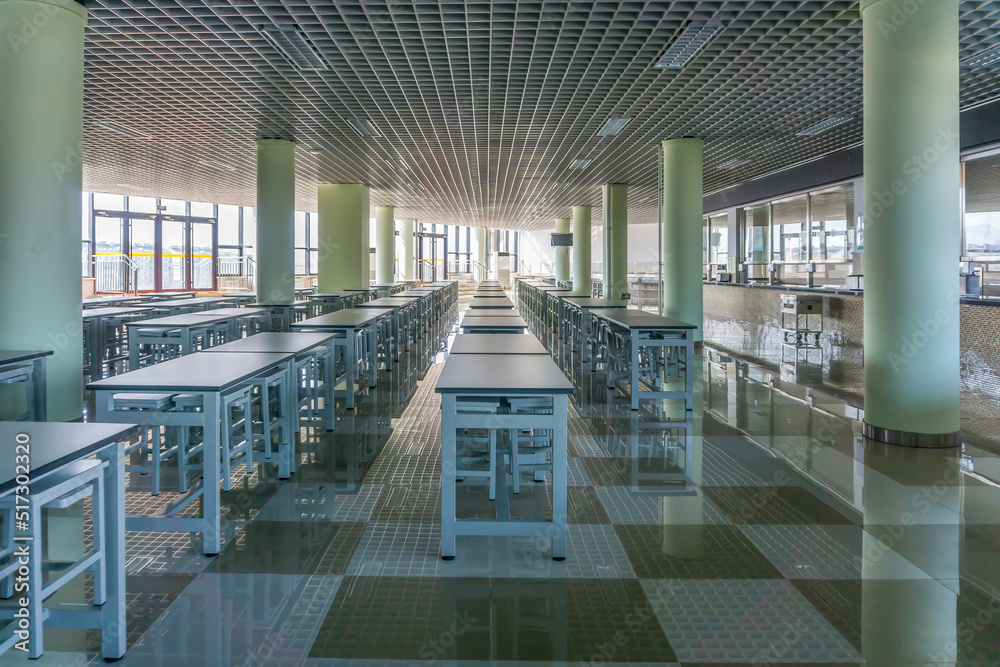 Clean school cafeteria with many empty seats and tables. Stock Photo ...