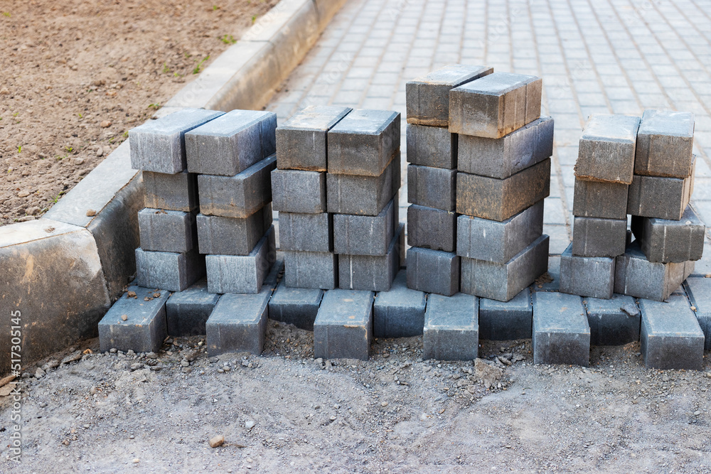 Pavement repairs and paving slabs laying on the prepared surface, with ...