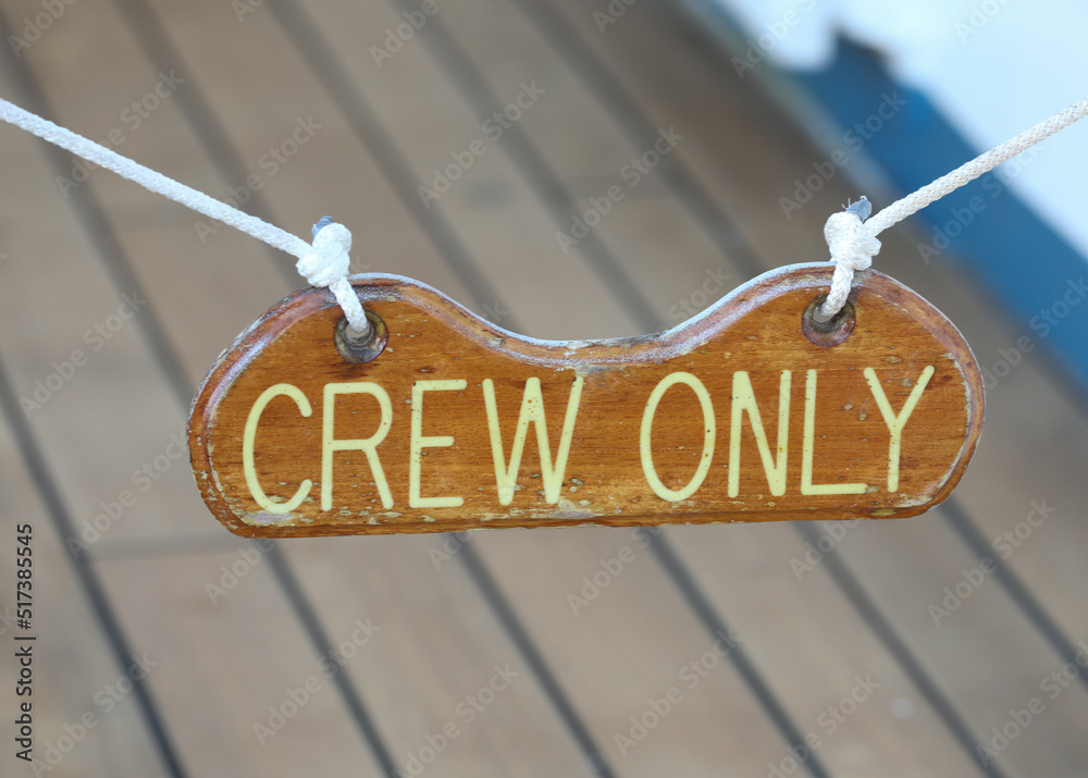 Crew only sign on a cruise ship open deck. Stock Photo | Adobe Stock