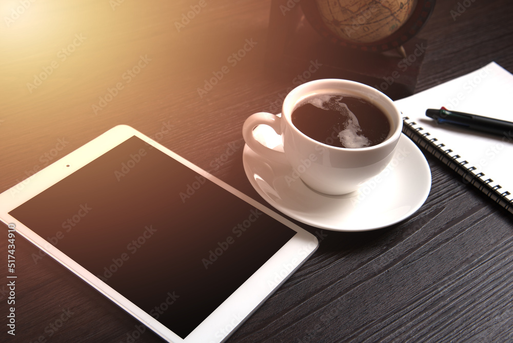 Tablet and black coffee on wooden table with Digital Earth world map ...