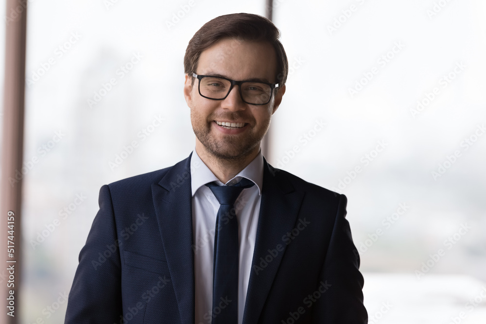 Happy successful business leader in glasses and formal suit head shot ...