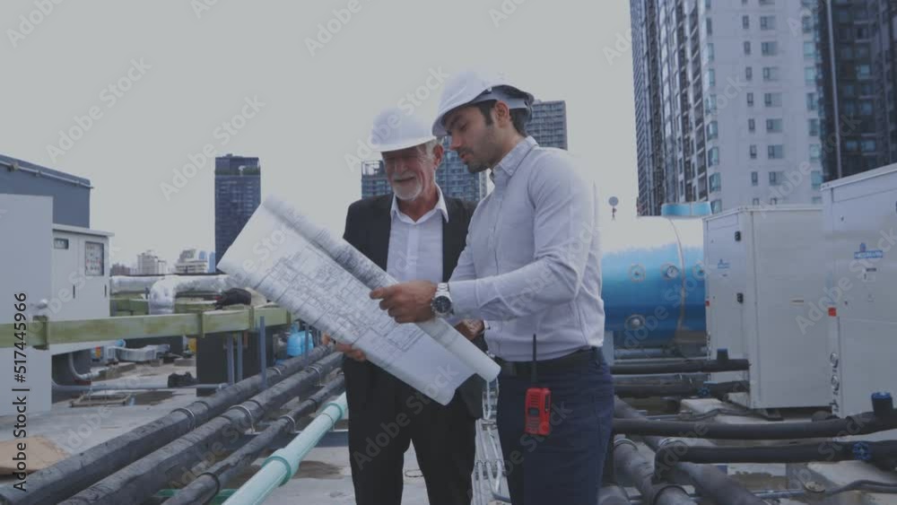Two experts inspect real estate construction site with civil engineer ...
