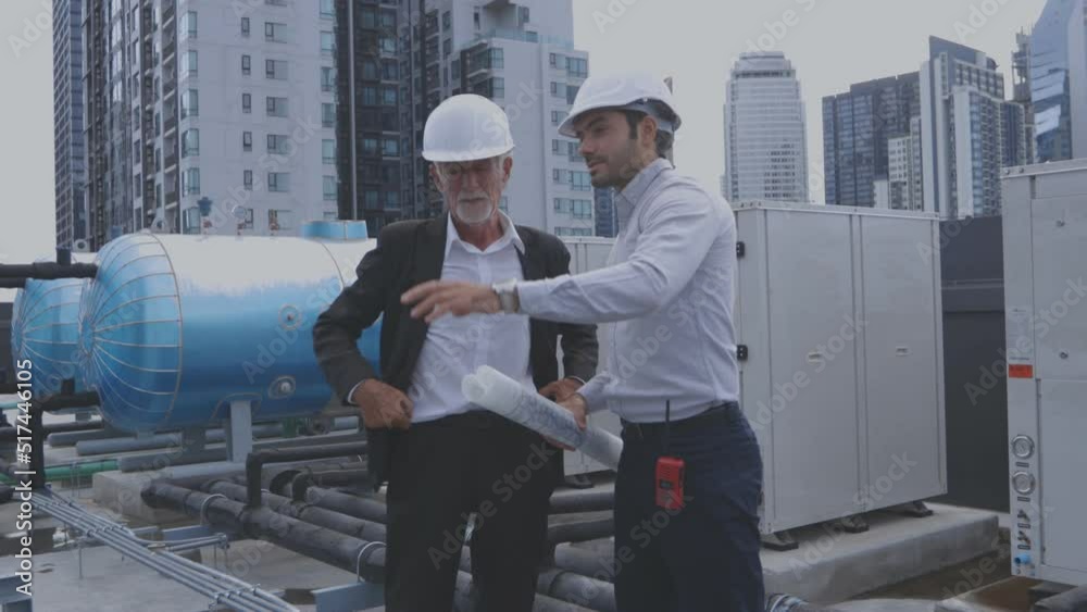 Two experts inspect real estate construction site with civil engineer ...