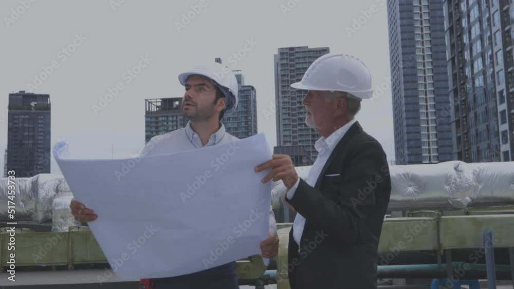 Two experts inspect real estate construction site with civil engineer ...