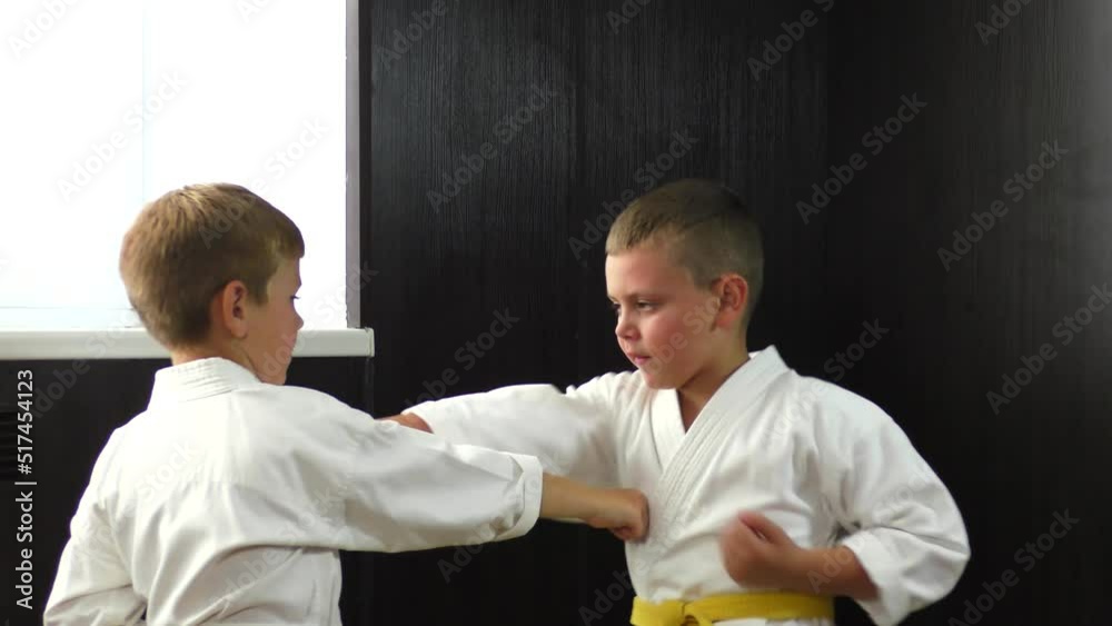 Two athlete boys with red and blue overlays on their hands do active ...