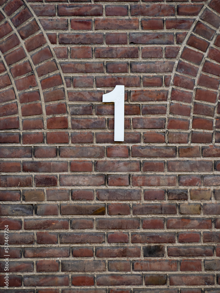 brick wall with house number 1 Stock Photo | Adobe Stock
