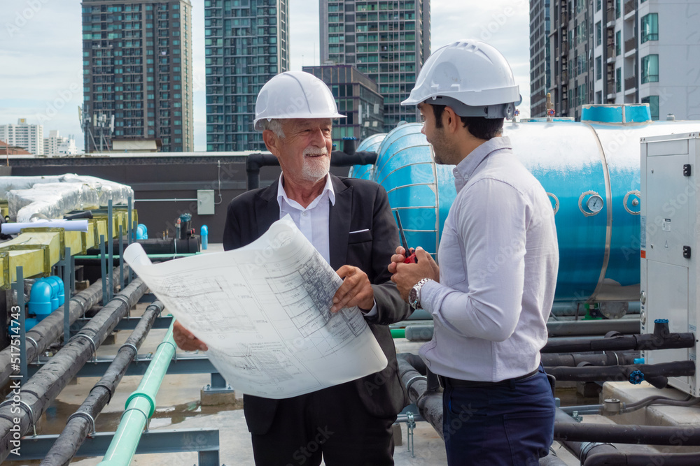Two experts inspect real estate construction site with civil engineer ...