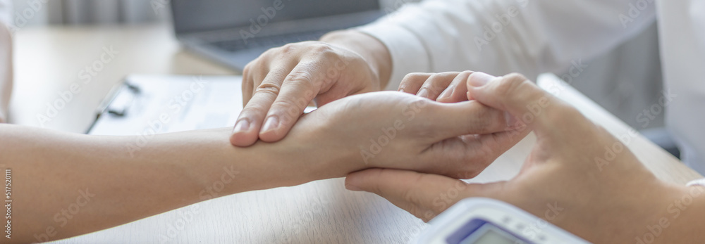 Medical professional measures the pulse of a male patient's wrist to ...