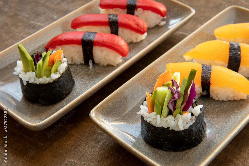 Vegan sushi: nigiri with red pepper and golden tomato topping and ...