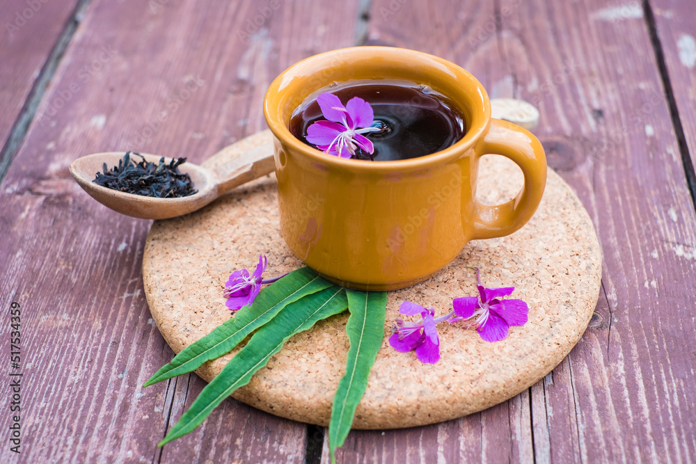 Ivan tea or chai. Herbal tea from fireweed flowers in a cup on natural ...