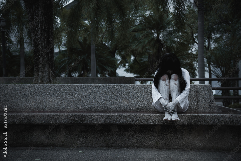 Scary woman ghost horror creepy sitting her hugging his knees, happy ...