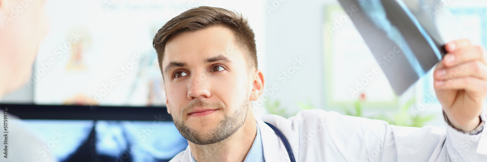 Smiling doctor talking with patient about good x ray results Stock ...