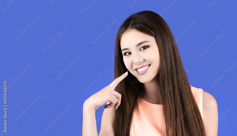 Beautiful korean woman with perfect smile showing her finger on her ...