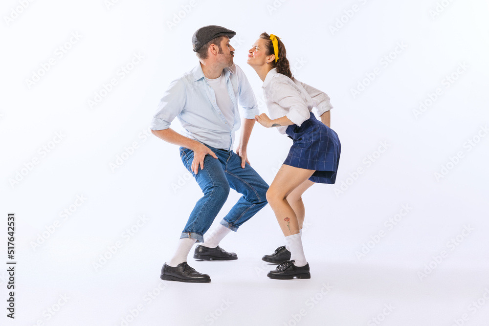 Portrait of young beautiful couple, man and woman, dancing retro dance ...