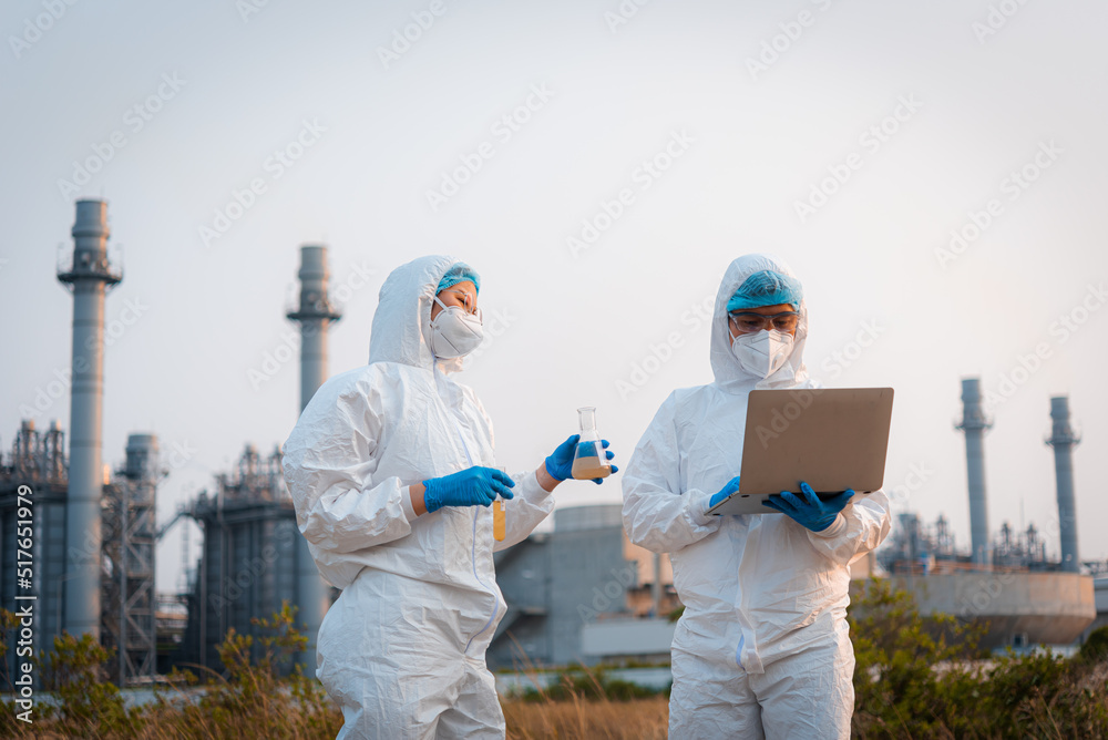 Ecologist taking samples of water with test tube from city river to ...