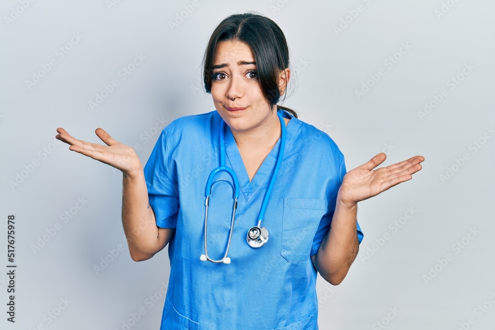 Beautiful hispanic woman wearing doctor uniform and stethoscope ...