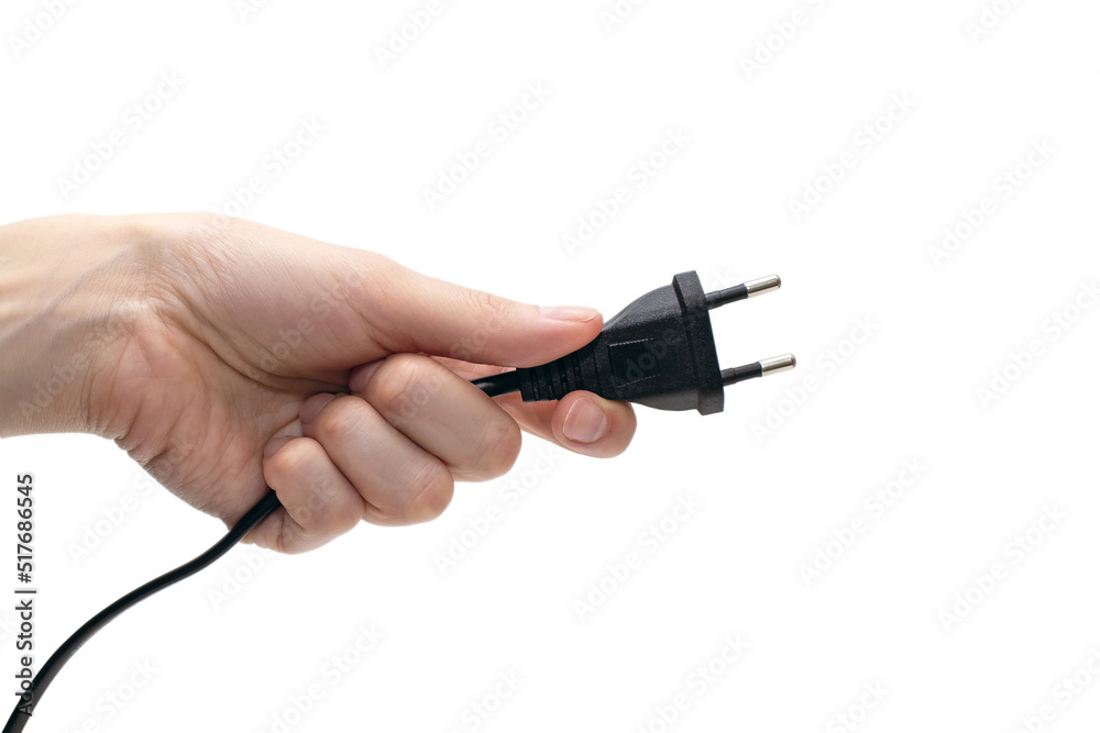 Electric plug for a socket in a hand on a white background. The concept ...