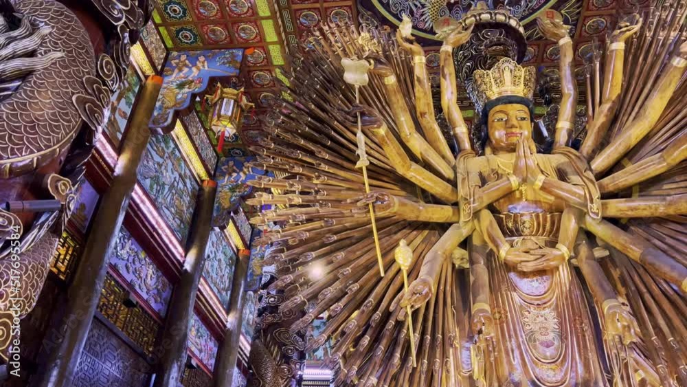 Panning upward view spectacular of Guan Yin Bodhisattva wood carved and ...