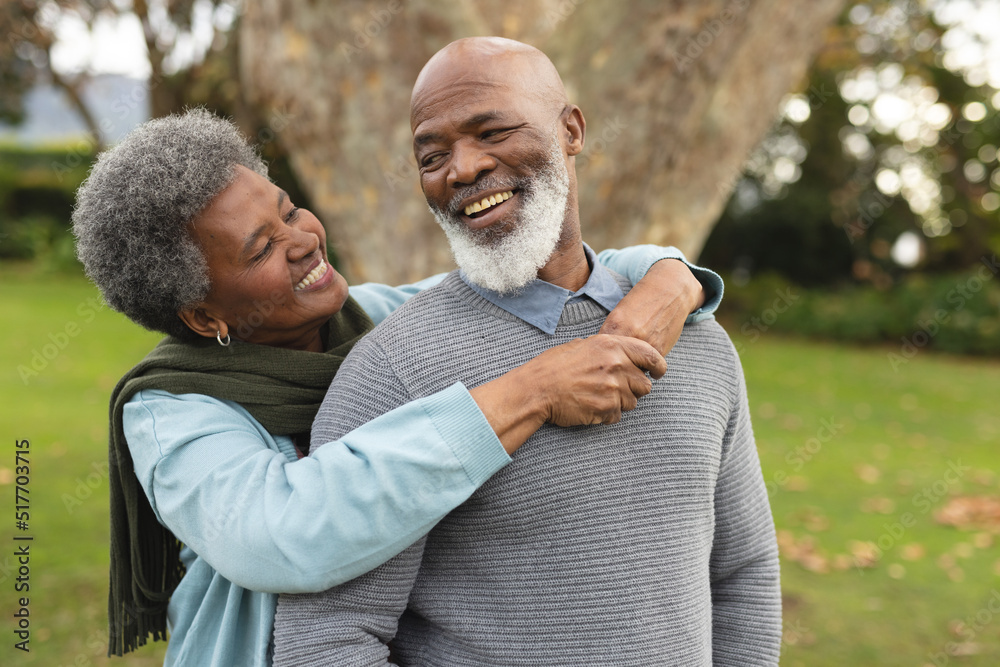 Image of happy african american senior couple posing at camera outdoors ...