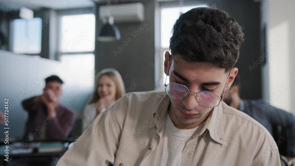 Close-up young depressed student sitting in classroom at desk alone ...