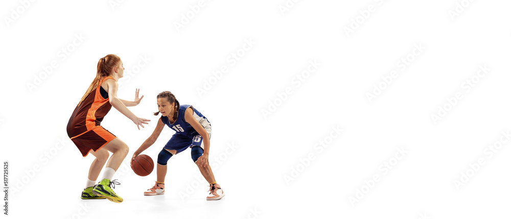Play defense. Two basketball players, young girls, teen training with ...