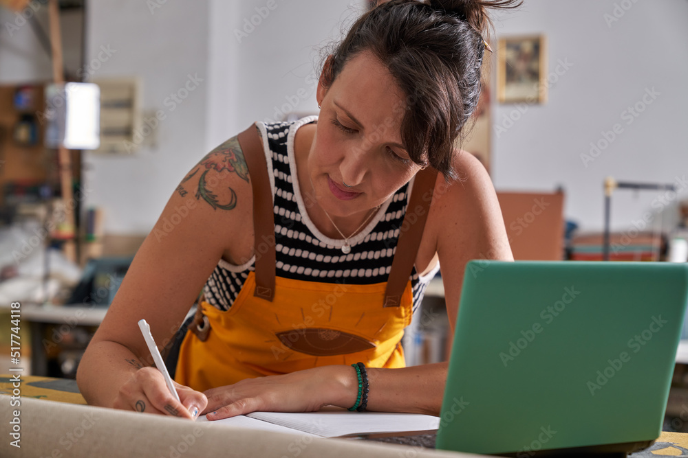 Content lady drawing in sketchbook in light atelier Stock Photo | Adobe ...