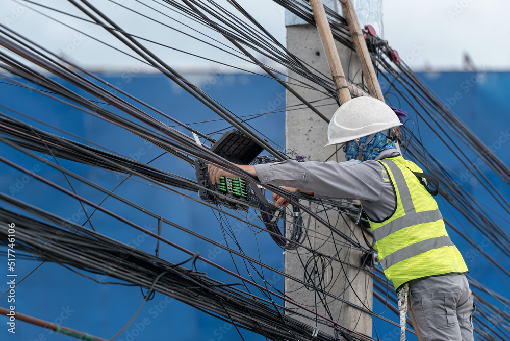 Fotografia do Stock: An electrical engineer checks and repair the fiber ...
