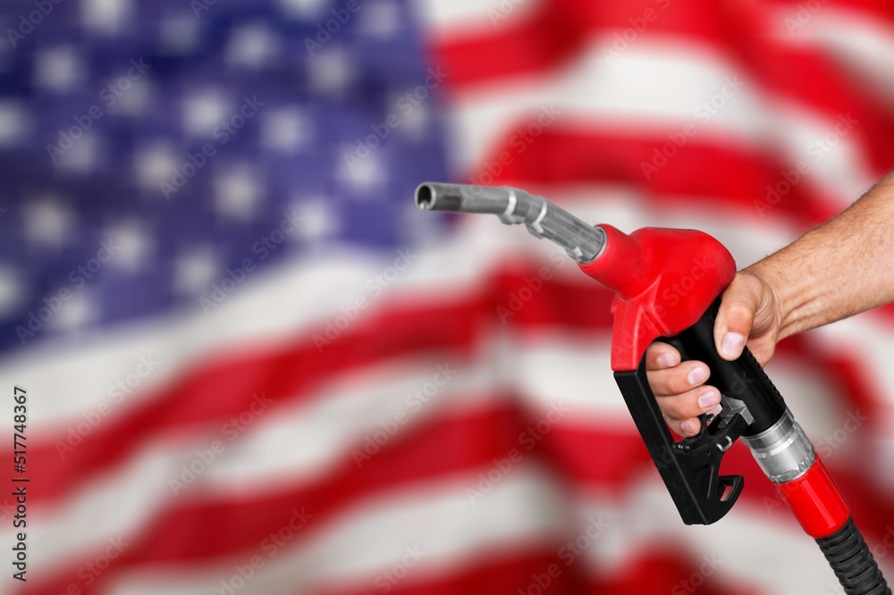Gas dripping from fuel nozzle with American flag. Gasoline shortage ...