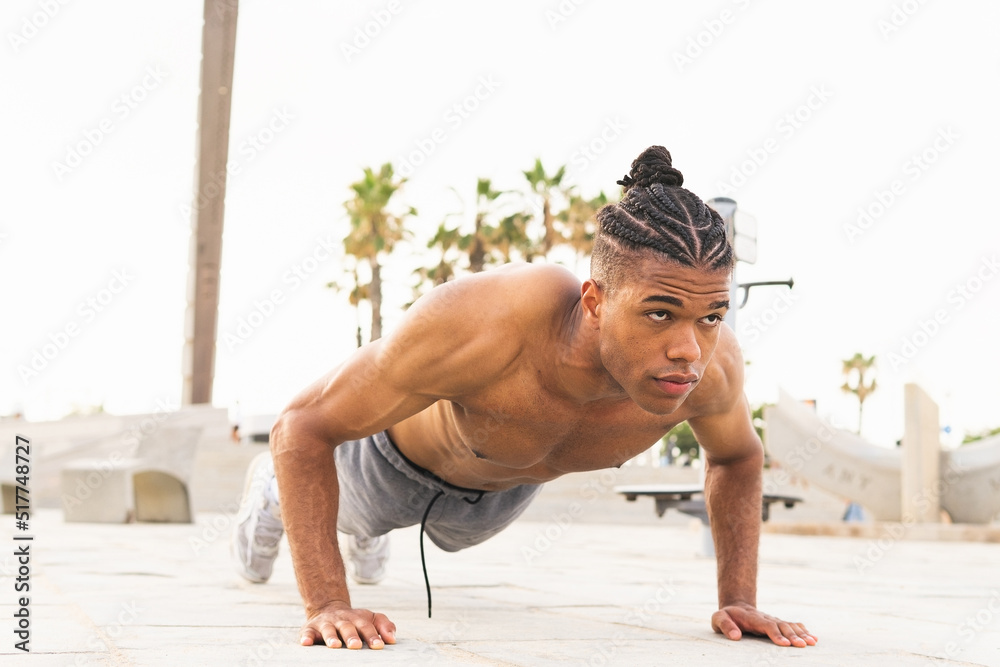 Black man doing push ups on street Stock Photo | Adobe Stock
