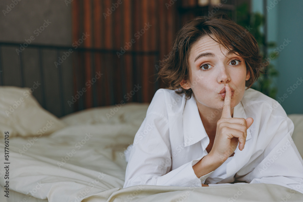 Full body secret young woman wear white shirt pajama she lying in bed ...