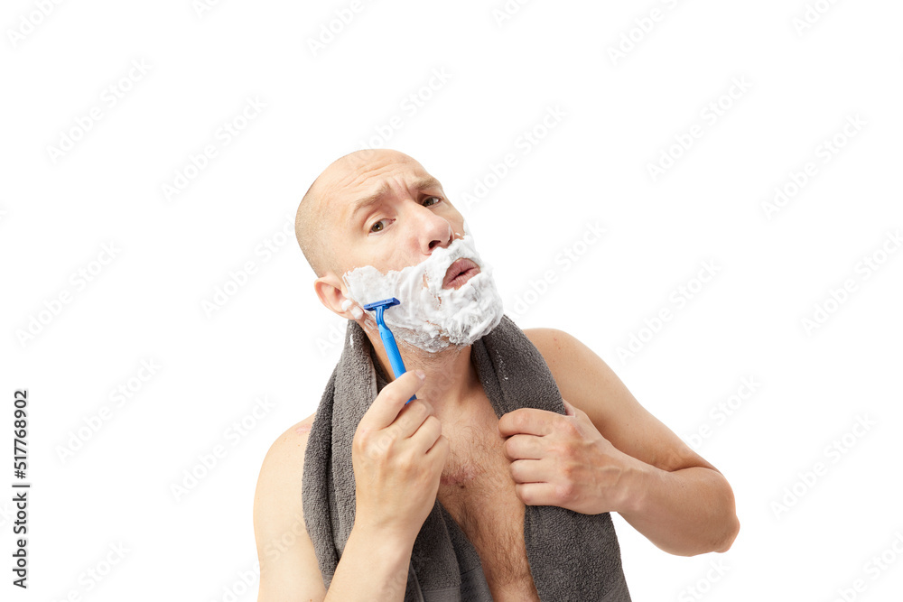 Bald man saving beard with shave foam over face holding razor scared ...