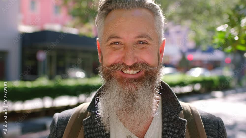 Smiling senior man laughing on a city street. Breaking into a chuckle ...