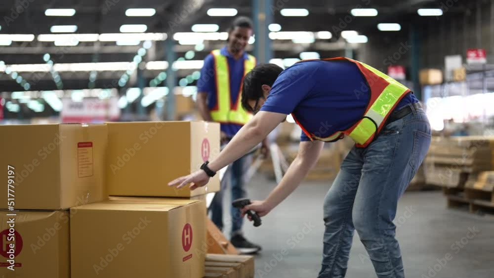 Warehouse worker pulling manual hand pallet lift carry stacked boxes to ...