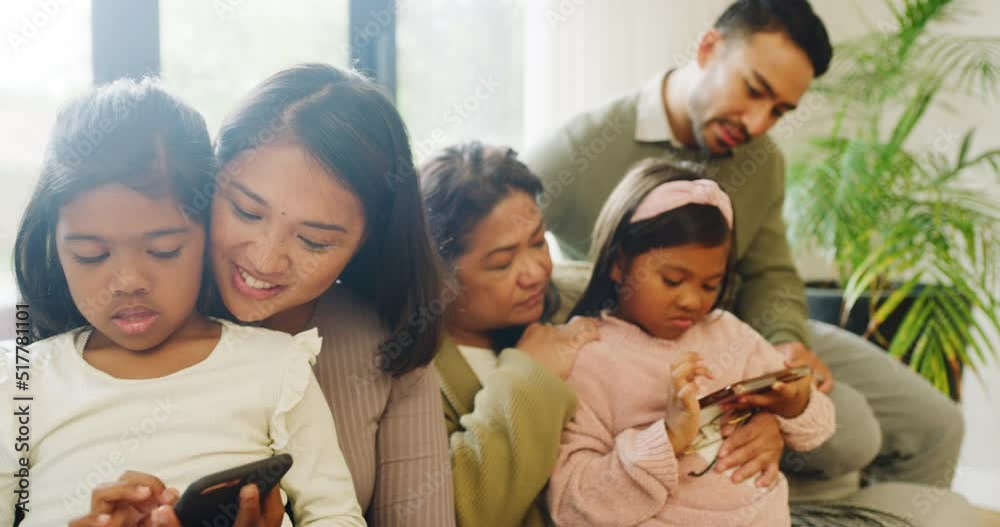 Happy family using phones to browse online and watch videos while ...