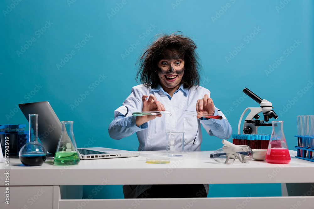 Goofy looking maniac scientist with dreadful face mixing substances ...