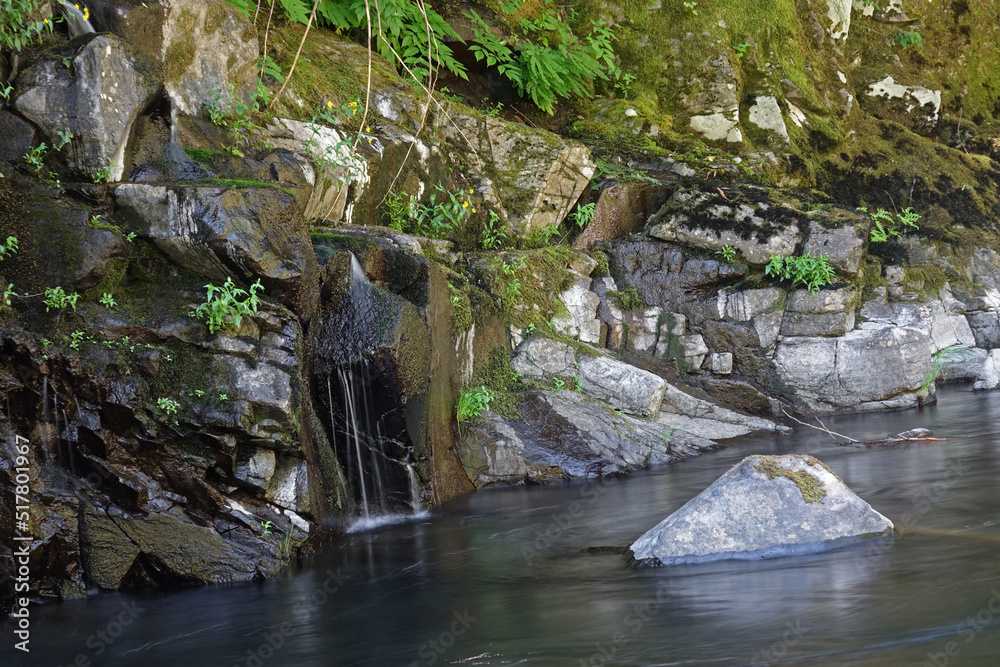 Water Flow, Rocks and Moss - River water flows pass a hillside water ...