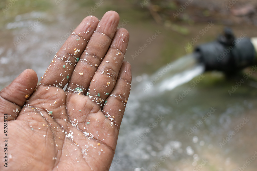 Close up shot of microplastics on people hand from borewell water ...