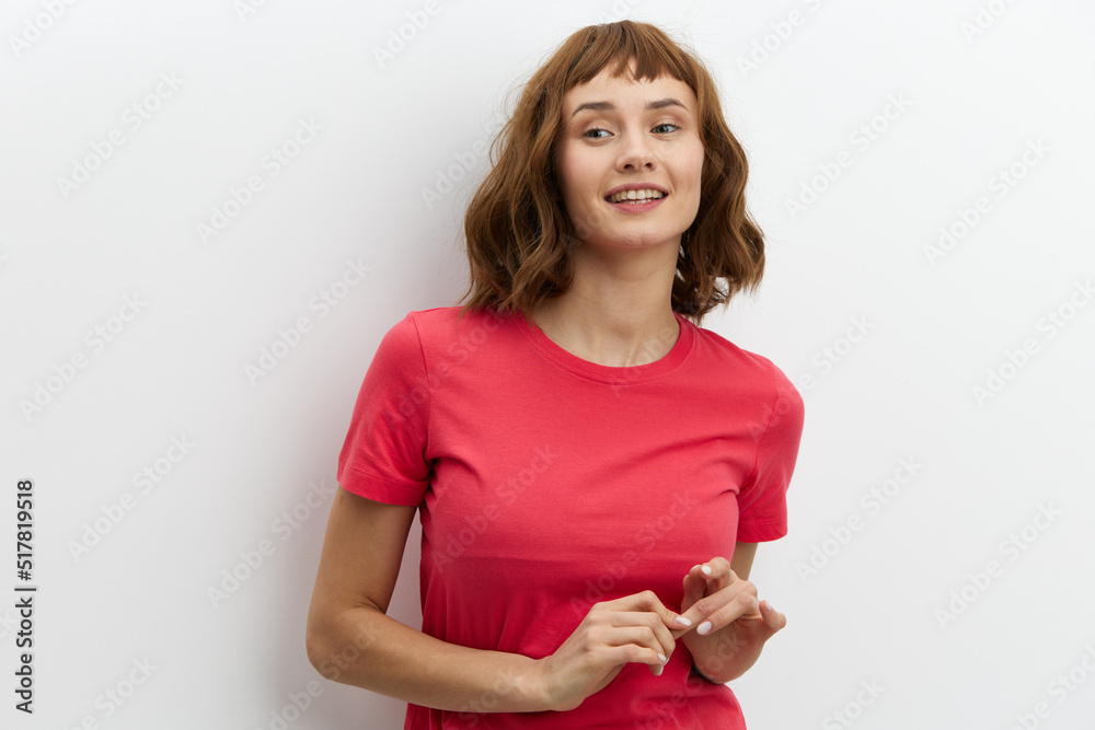 a beautiful, sweet, modest woman with red hair stands on a white ...