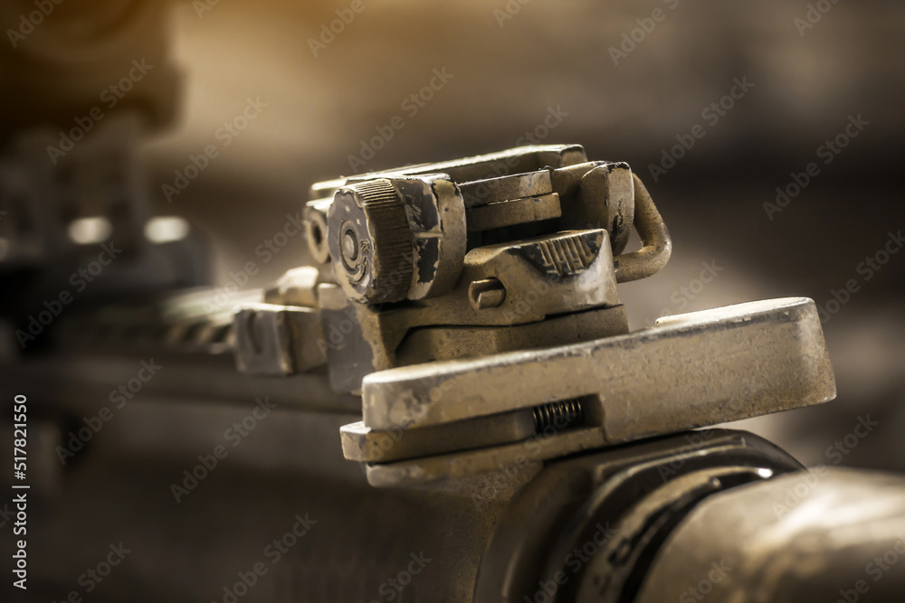 Close-up of flip rear sight and charging handle of assault rifle AR15 ...