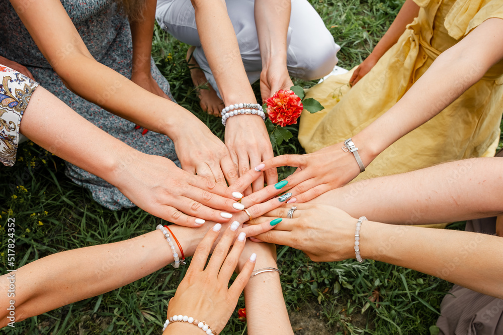 Many hands together: group of people joining hands. Female models ...