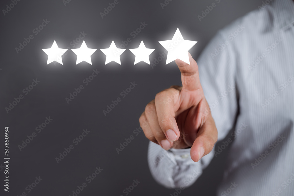 Businessman pointing a five-star symbol to increase the company's ...