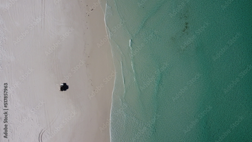 Aerial picture. Car parked on the beach. View from the sky, shallow ...