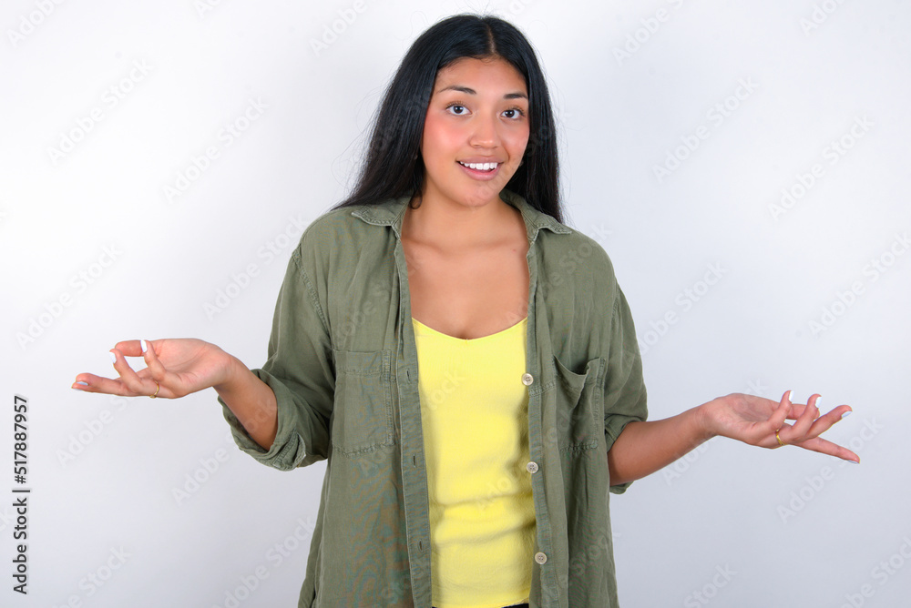 So what? Portrait of arrogant young brunette woman wearing green ...