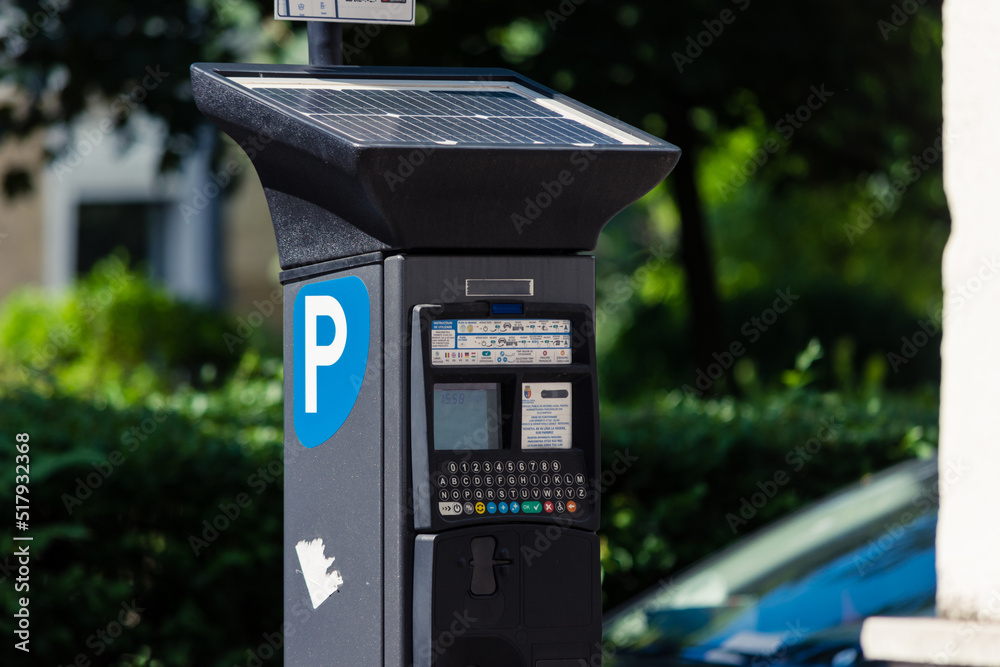 Working parking meter with solar panel in a public space with lots of ...