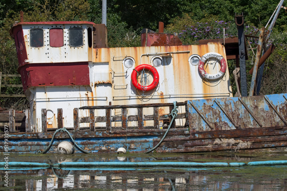 A sunken boat decayed and rusty. With rotting wooden decks portraying ...