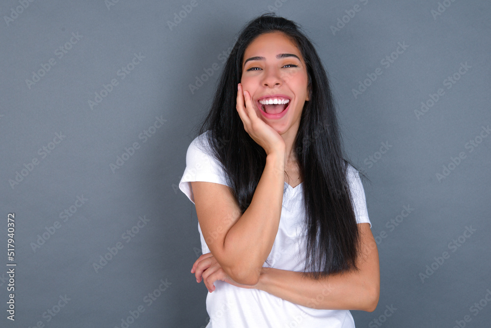 Shocked, astonished young beautiful brunette woman wearing white t ...