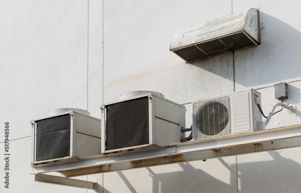 Air conditioner compressor installed in old building. Outdoor split ...